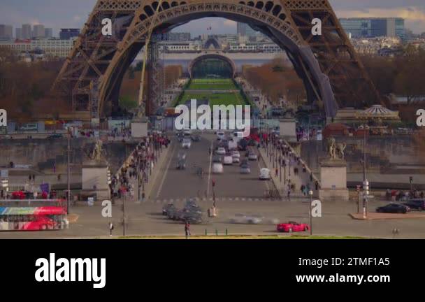 Cars and people move along the road near the tower on the bridge over ...