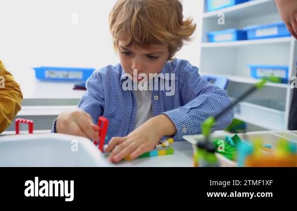 Robotics programming class. Children construct and code Robot. STEM ...