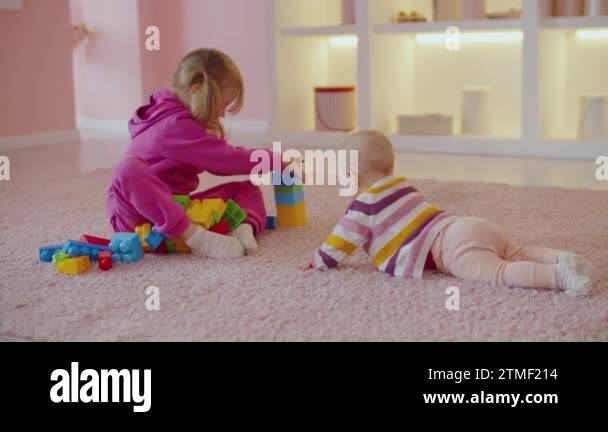 Joyful cute preschool age girl and cheerful infant baby enjoying ...