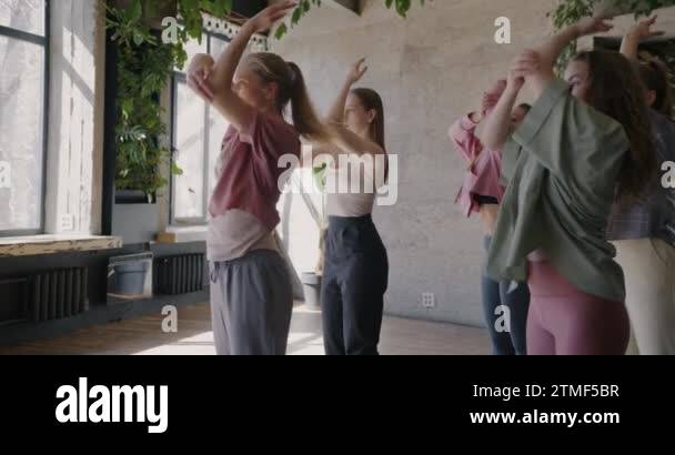 Creative millennials learning contemporary dance in light studio ...