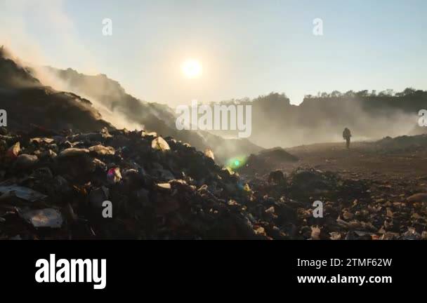 Burning pile of garbage at dump ground or landfill releasing toxic ...