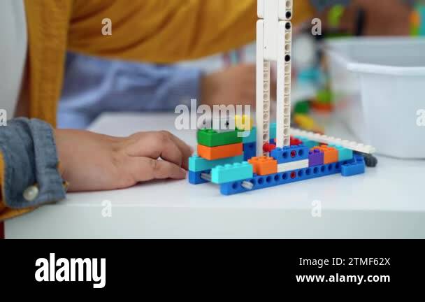 Robotics programming class. Children construct and code Robot. STEM education using constructor ...