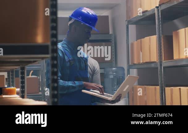 African american worker counting products on shelves, checking stock ...