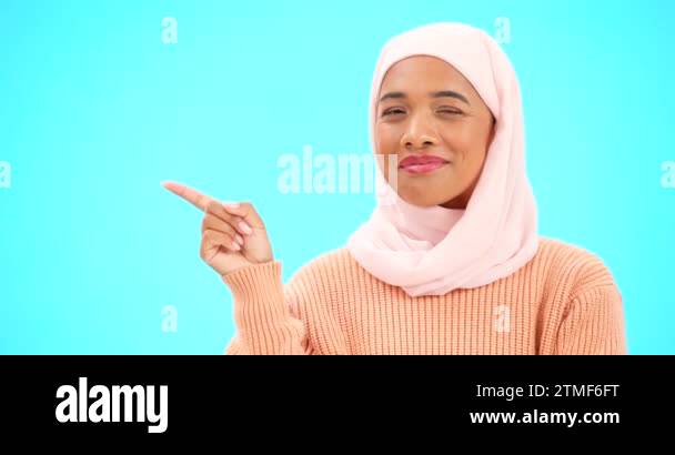 Woman, pointing finger and space for happy muslim announcement with ...