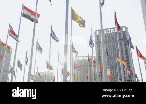 bottom view footage of flags of world waving on blue sky background ...