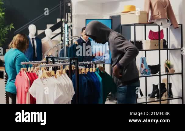 Shoplifter trying to stole trendy merchandise from shopping centre ...