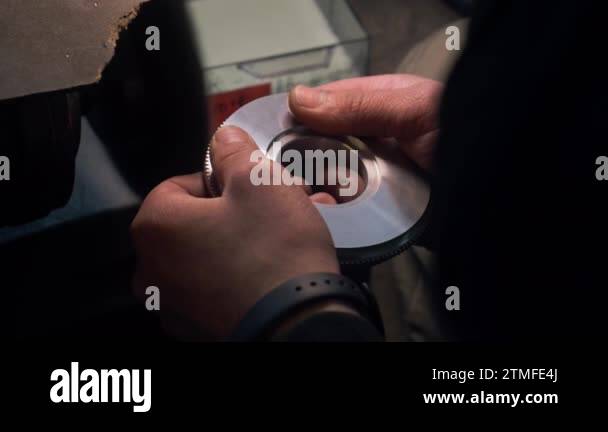 Technician cleans cut place of metal workpiece by grinding machine ...