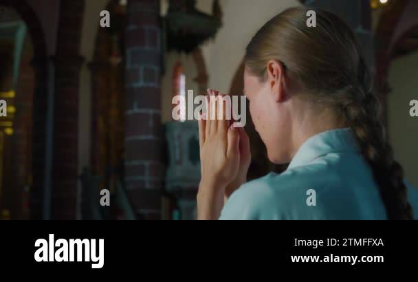 Woman praying to God with HOPE and FAITH in church. Close-up religious ...