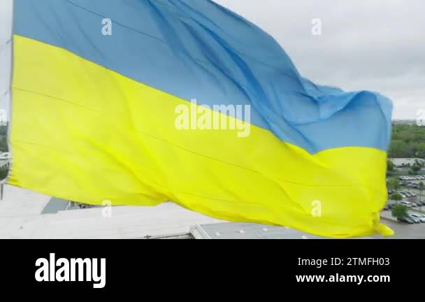 Aerial zoom out of Ukraine flag waving background. Close up macro view ...