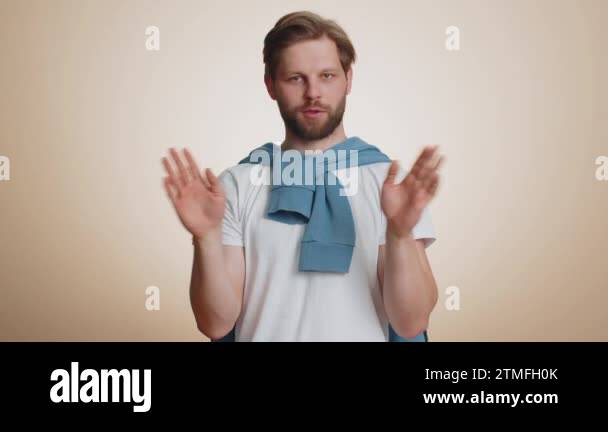 I am dont want it, not me. Confused young caucasian man pointing ...