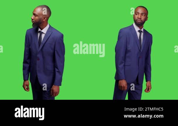 Office worker looking left and right in greenscreen studio, checking ...