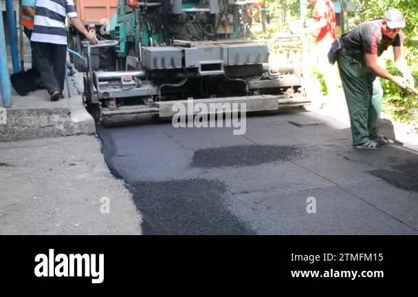 Large asphalt paving machine and people. Paver, paving machine. Big old ...