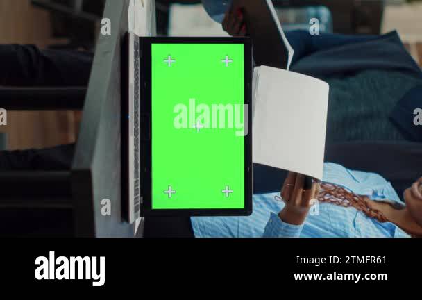 Vertical video: Employees team analyzing papers using greensceen on ...