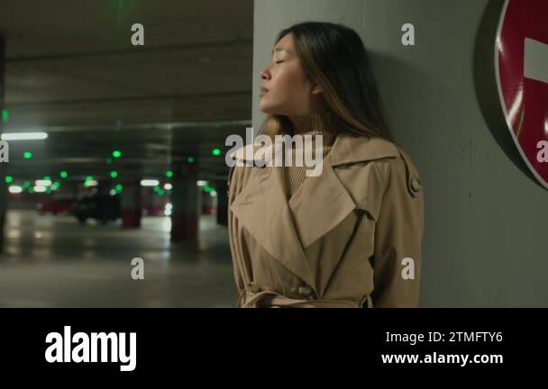 Frightened Asian ethnic chinese korean woman hiding from danger pursuit ...