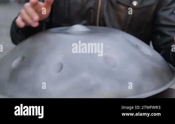 Young Street Artist Performing On The Street. Performer With Handpan Or ...
