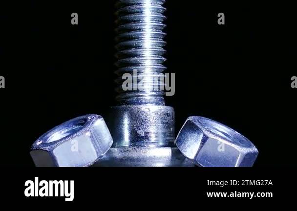 Two Nuts and bolt rotates against dark background. 4K macro Stock Video ...