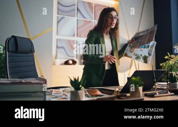 Emotional young businesswoman arguing at video meeting standing near ...