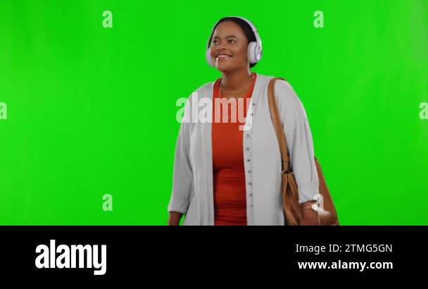 Happy, green screen and black woman with headphones, walking and ...
