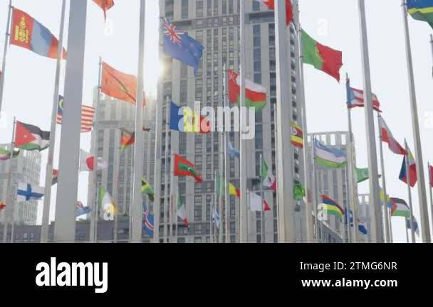 bottom view footage of flags of world waving on blue sky background ...