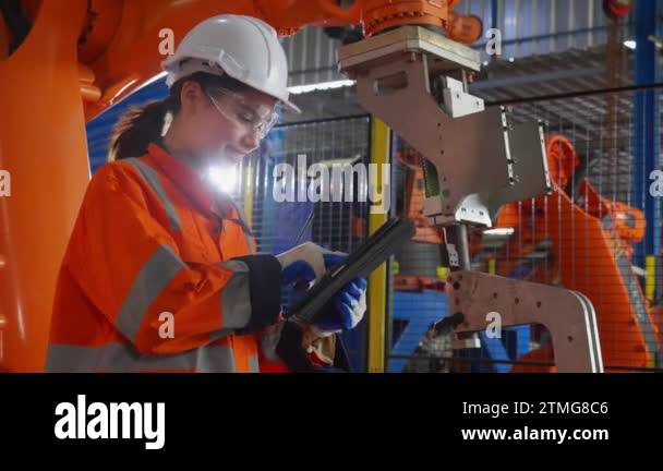 Young asian engineer woman inspection robot arms technology ...