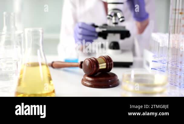 Medical examiner looks through microscope and examines evidence from ...