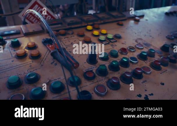 Handheld following shot of a workers finger pushing factory console ...