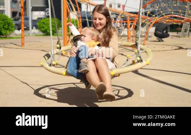 Little baby boy getting upset and refusing swinging in swing with ...