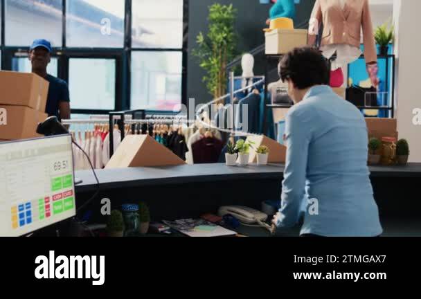 Store worker putting courier to sign distribution report, discussing ...