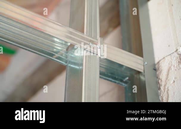 Galvanized metal U profile is connected by self-tapping screws close-up ...