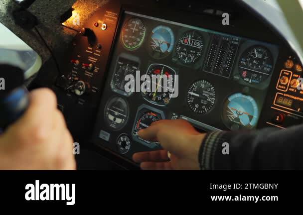 Hand of teacher showing student cockpit panel inside flight simulator ...