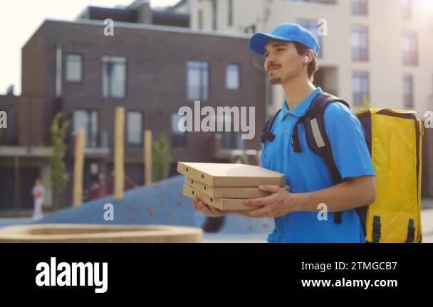 Side View of Caucasian Courier Man Carrying the Yellow Backpack ...