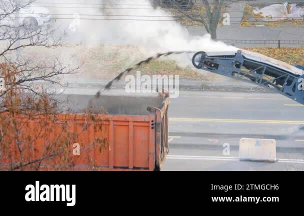 Road milling machine removes old asphalt. Hot smoking finely crushed ...