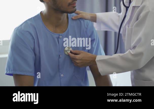 Happy doctor visiting young male patient to bring good news and ...
