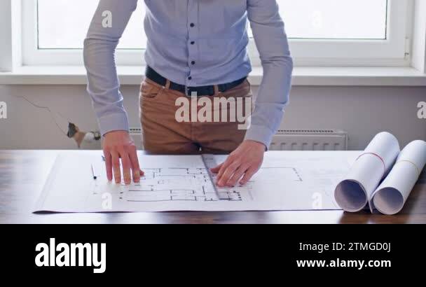 Architect drafts plan of important building project in light office ...