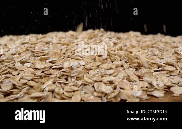Dry Oat Flakes Falling in Pile Raw Oatmeal on Black Rotating Background ...