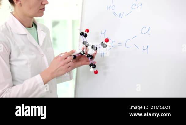 Scientist explains chemical formula written on whiteboard comparing ...