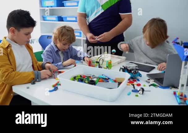 Robotics programming class. Children construct and code Robot. STEM ...