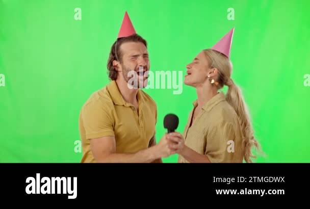 Green screen, party and couple singing karaoke for a birthday ...