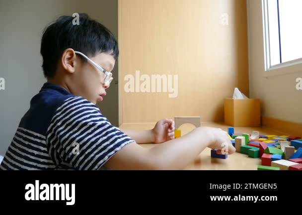 Young boy stacking blocks Stock Video Footage - Alamy