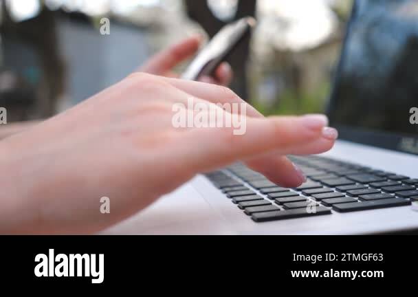 Female hands typing some text on keyboard of laptop. Unrecognizable ...