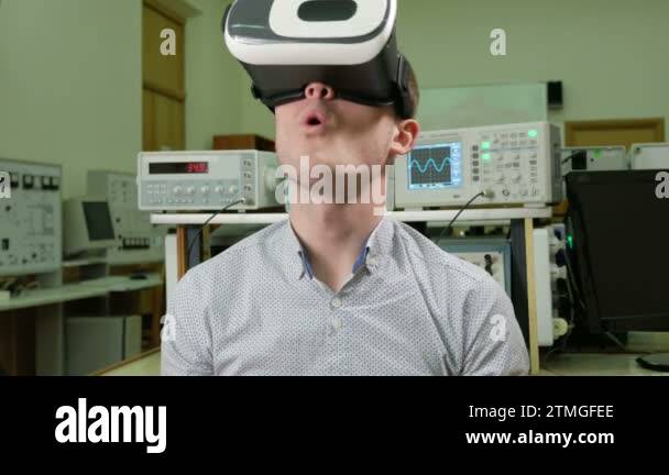 Young male student with glasses of virtual reality in the physical ...