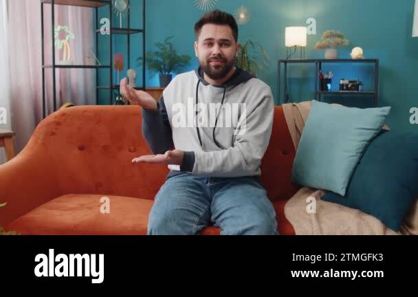 Young man raising hands asking what why reason of failure, disbelief ...