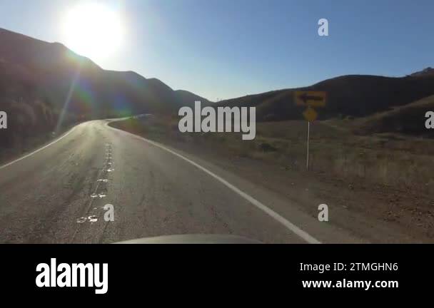 Front view of driving through suburban roads at moderate speed. Camera ...