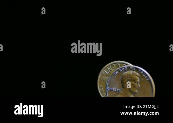 Two Coins of America one cent turns on black background . 4K 3840x2160 ...