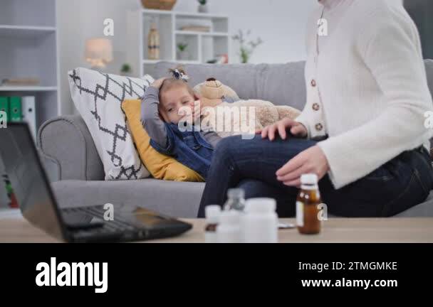 sickness of children, adorable little girl feeling unwell lying on ...
