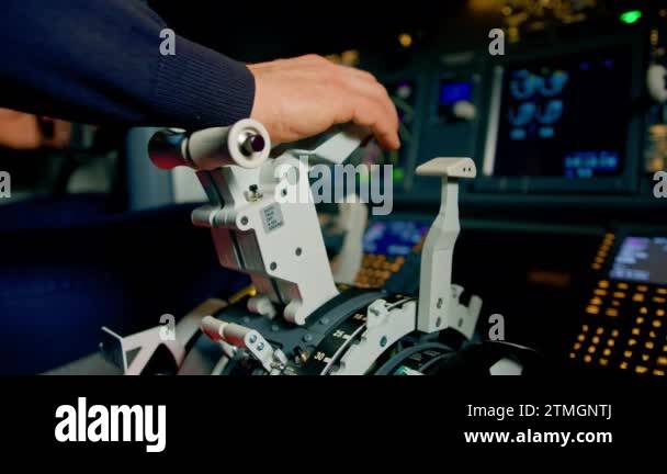 Close-up of a pilot's hand pressing the throttle in the cockpit of jet ...