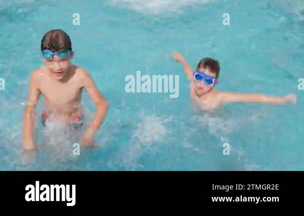 Cheerful children swimming pool playing water kids swimming boy water ...