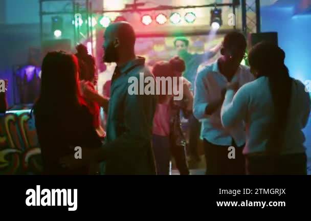 Happy persons enjoying slow music dance, partying together at ...