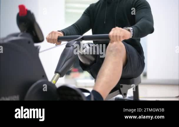 Disabled athlete with physical disability doing exercise routine indoor ...