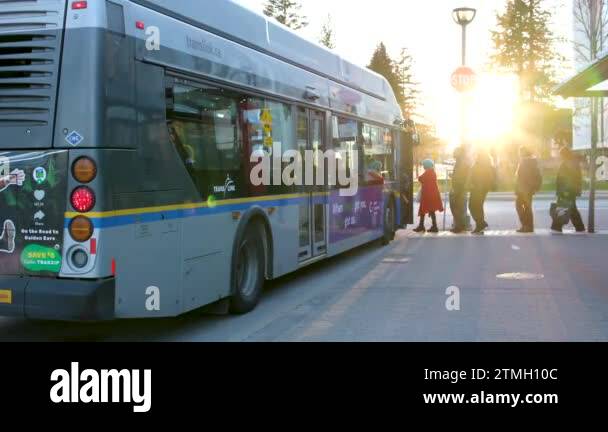 bus stop queue of people standing on the bus public transport sunset ...